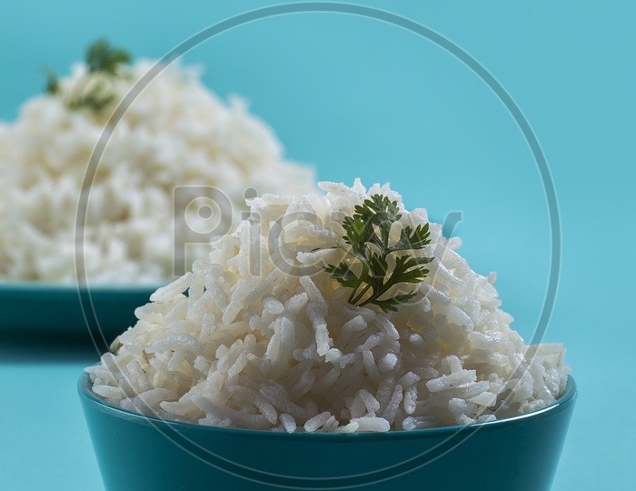 Image of Cooked plain white basmati rice in a blue plate and bowl on ...