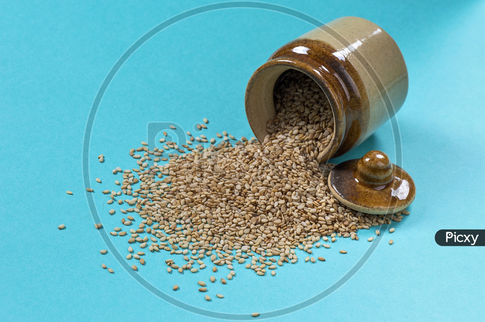 Image of Sesame Seeds in clay pot on blue background-YB615013-Picxy