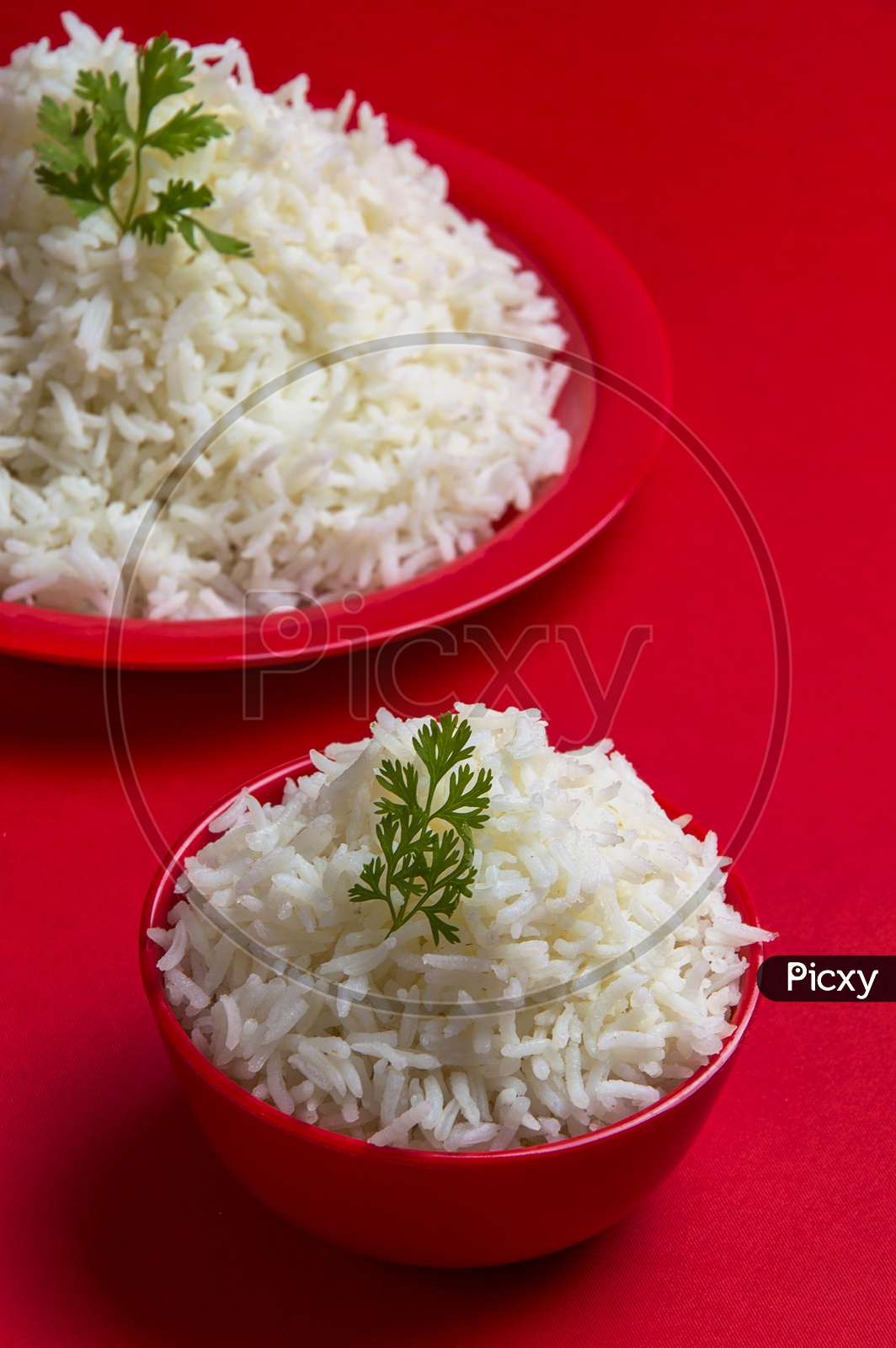 Image of Cooked plain white basmati rice in bowl and plate on red ...