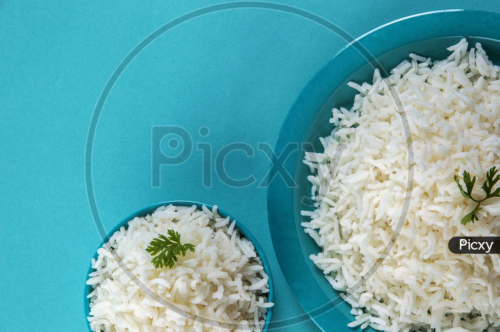 Image of Cooked plain white basmati rice in a blue plate and bowl on ...