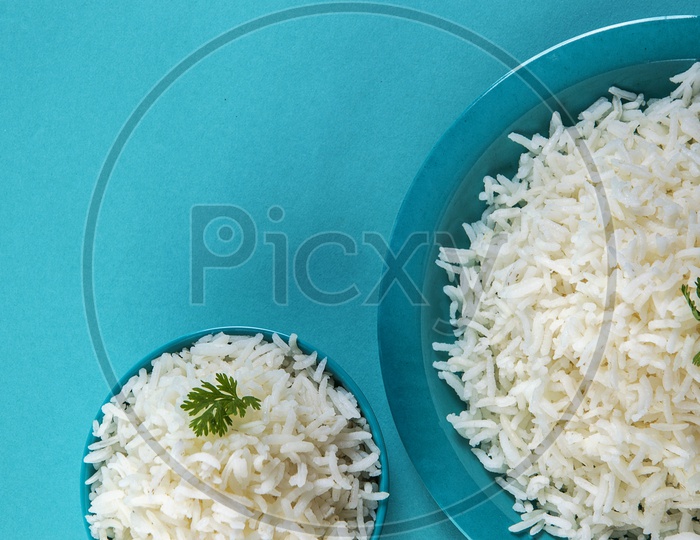 Image of Cooked plain white basmati rice in a blue plate and bowl on ...