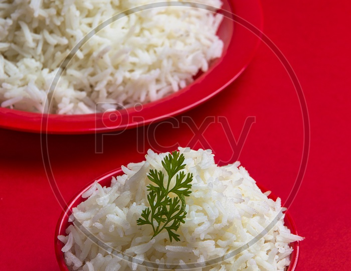 Image of Cooked plain white basmati rice in bowl and plate on red ...