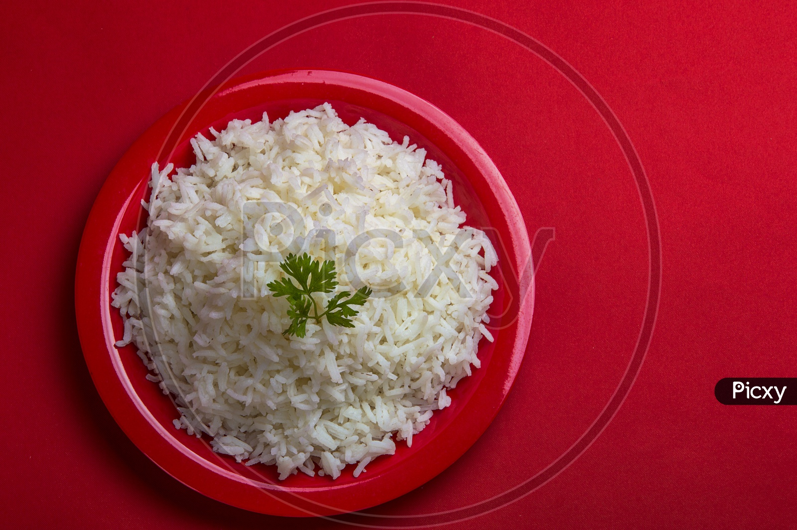 Image of Cooked plain white basmati rice in a red plate on red ...