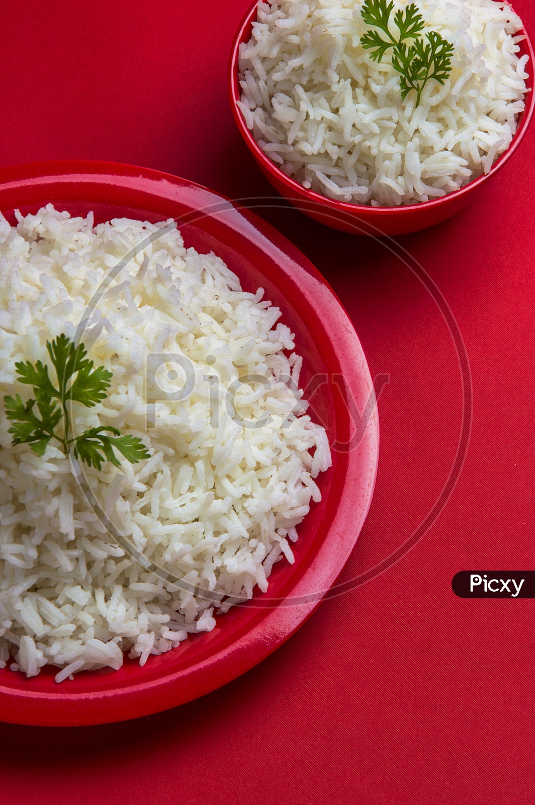 Image of Cooked plain white basmati rice in bowl and plate on red ...