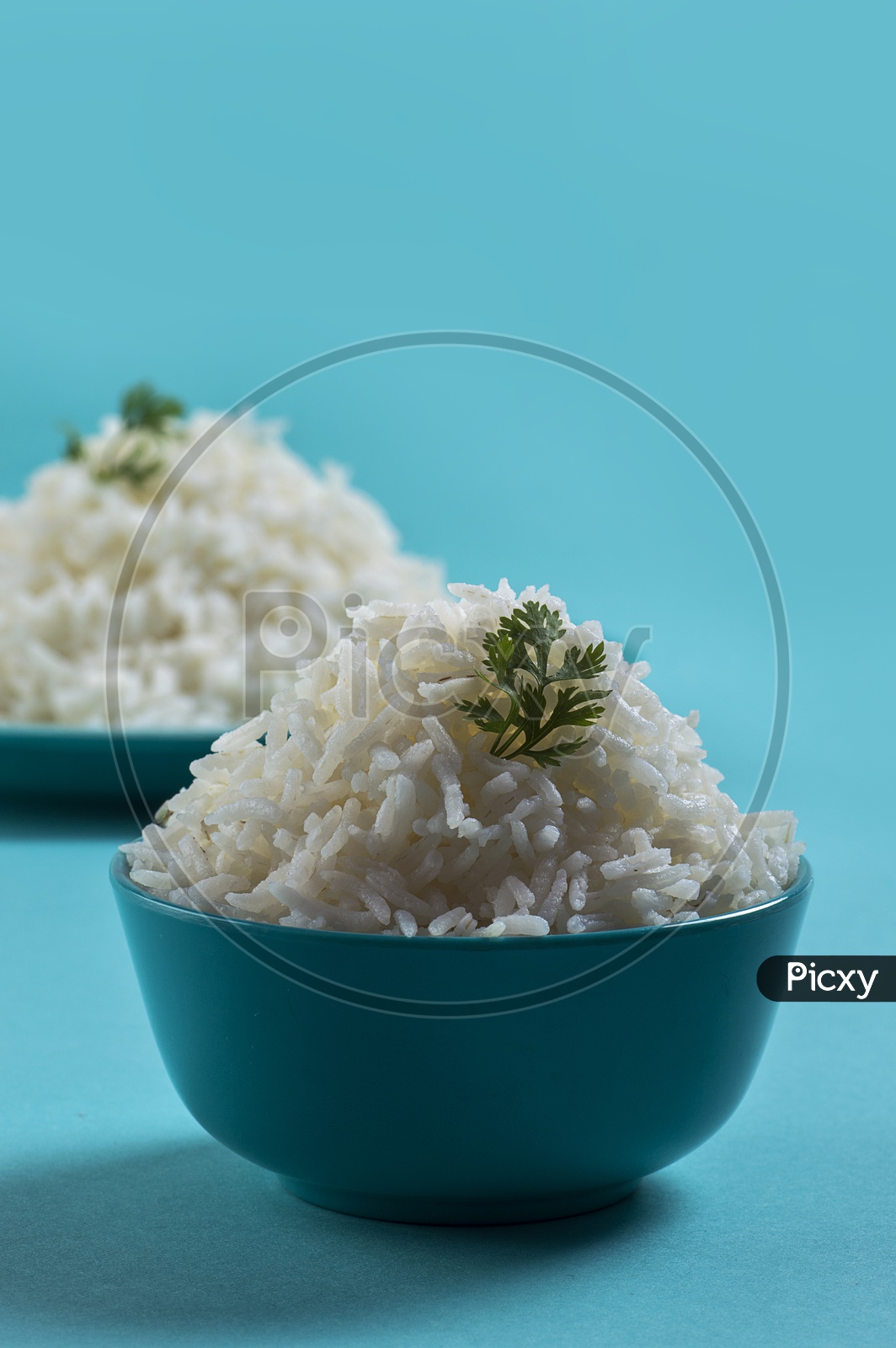 Image of Cooked plain white basmati rice in a blue plate and bowl on ...