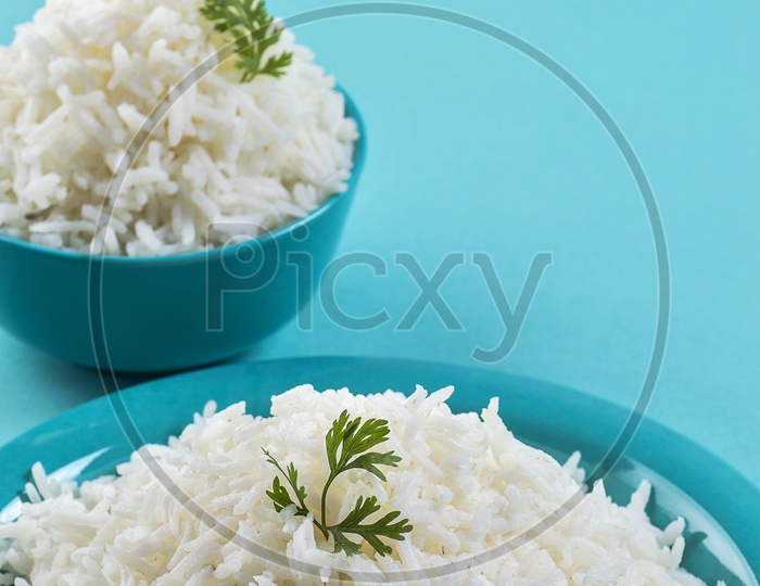 Image of Cooked plain white basmati rice in a blue plate and bowl on ...