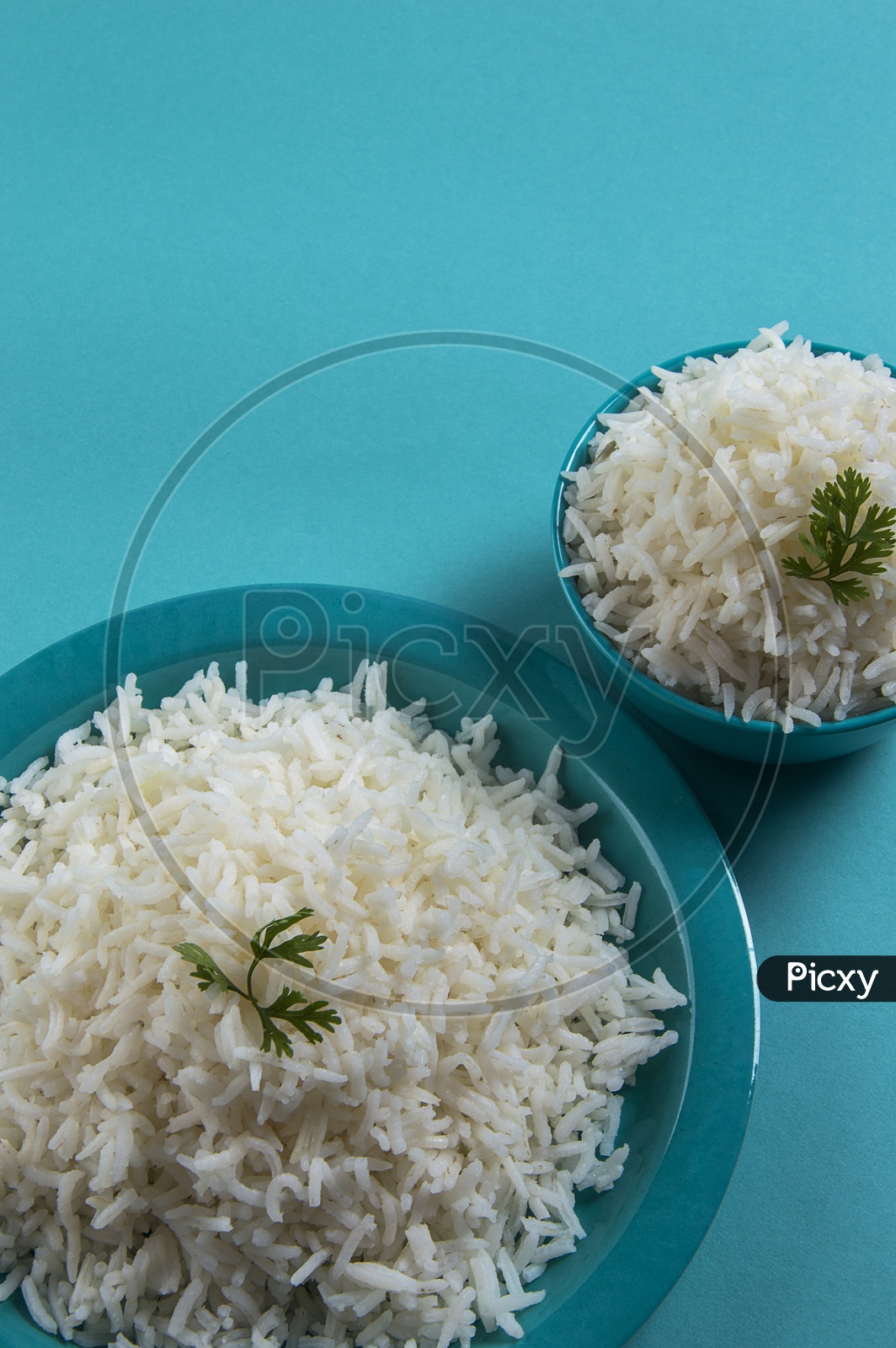 Image of Cooked plain white basmati rice in a blue plate and bowl on ...
