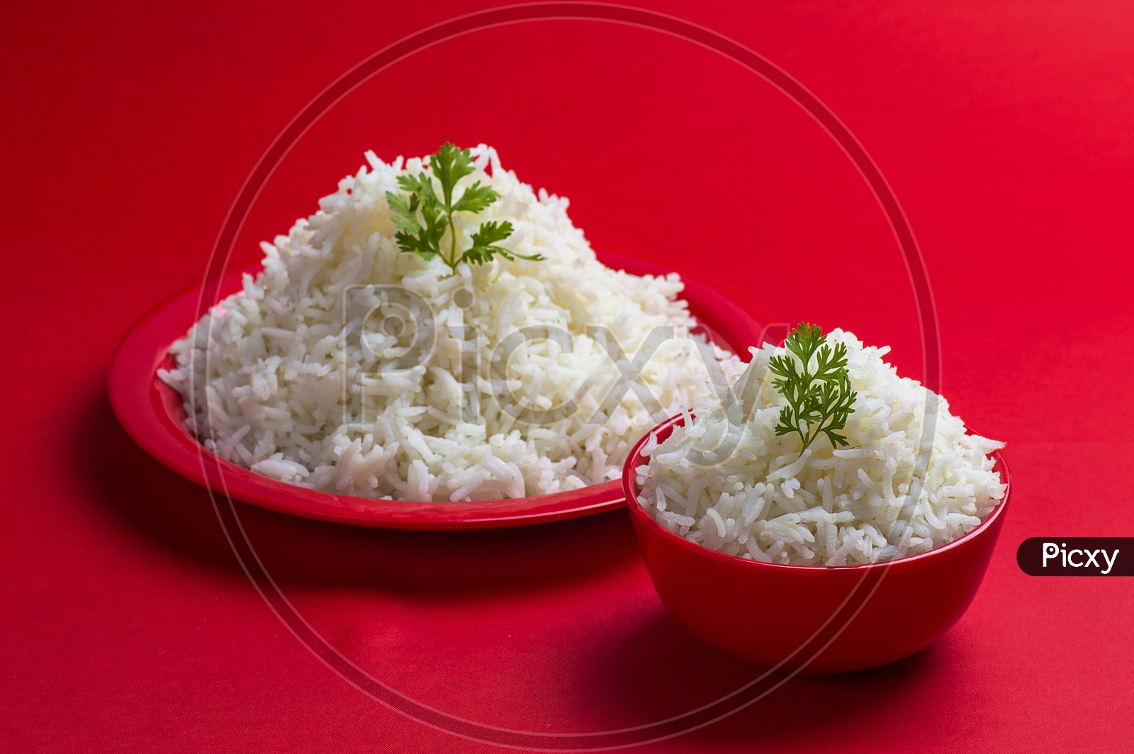 Image of Cooked plain white basmati rice in bowl and plate on red ...