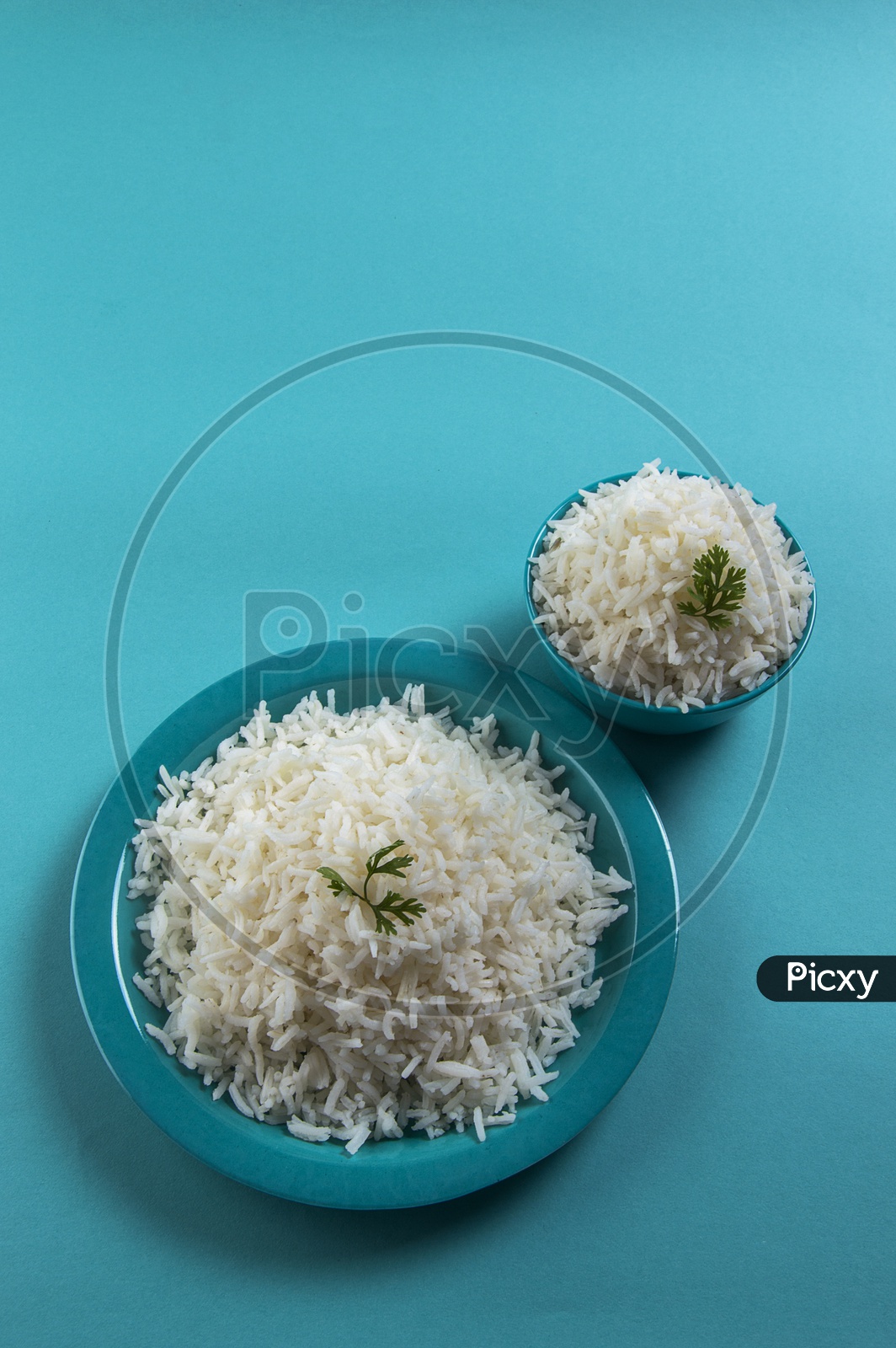 Image of Cooked plain white basmati rice in a blue plate and bowl on ...