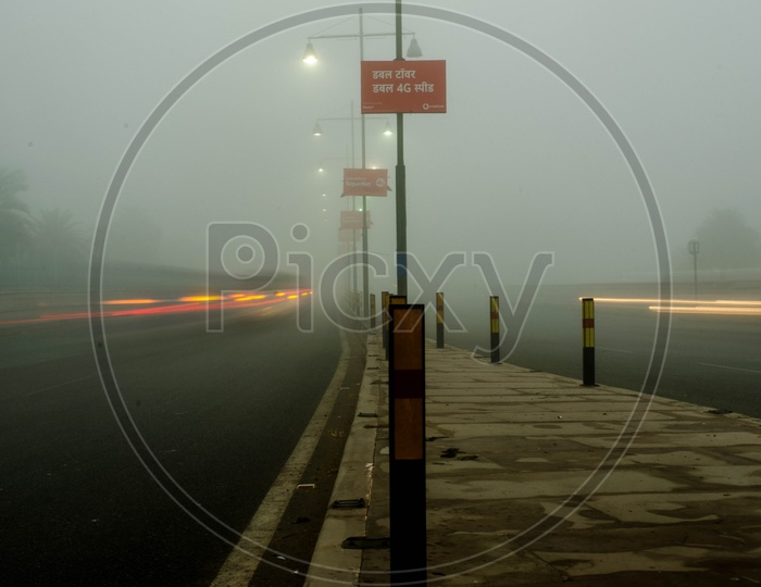 Image of A Pathway On a Road Divider With Railing Poles-WO799180-Picxy