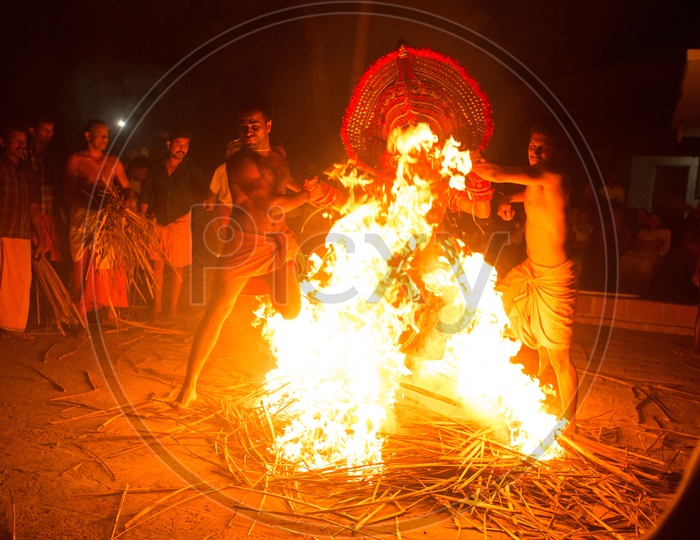 Image of Theyyam Artists Performing Around The Fire At Bhagawathi Amman ...