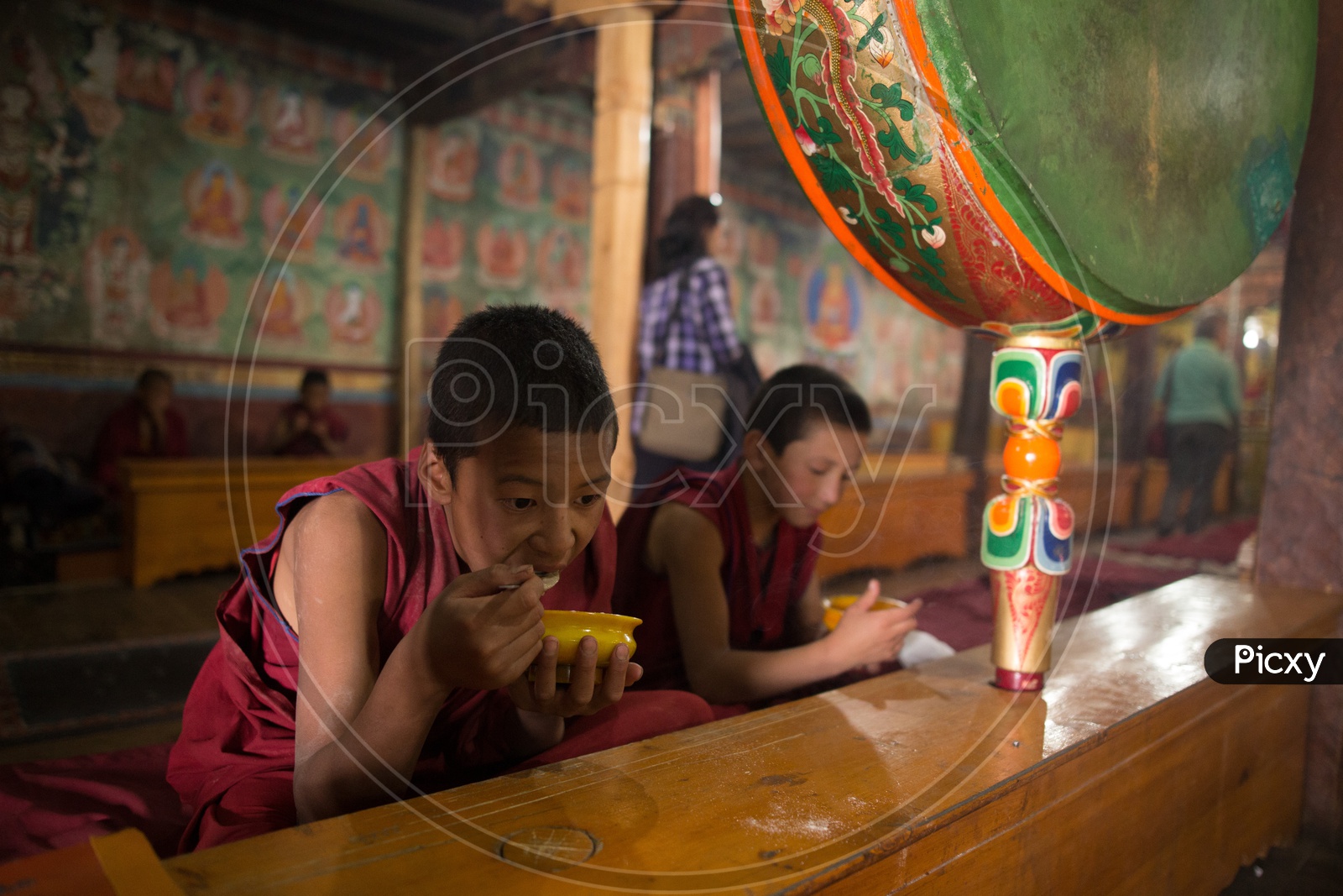 Image of Young Monks having sacred food in the monastery-QU287161-Picxy