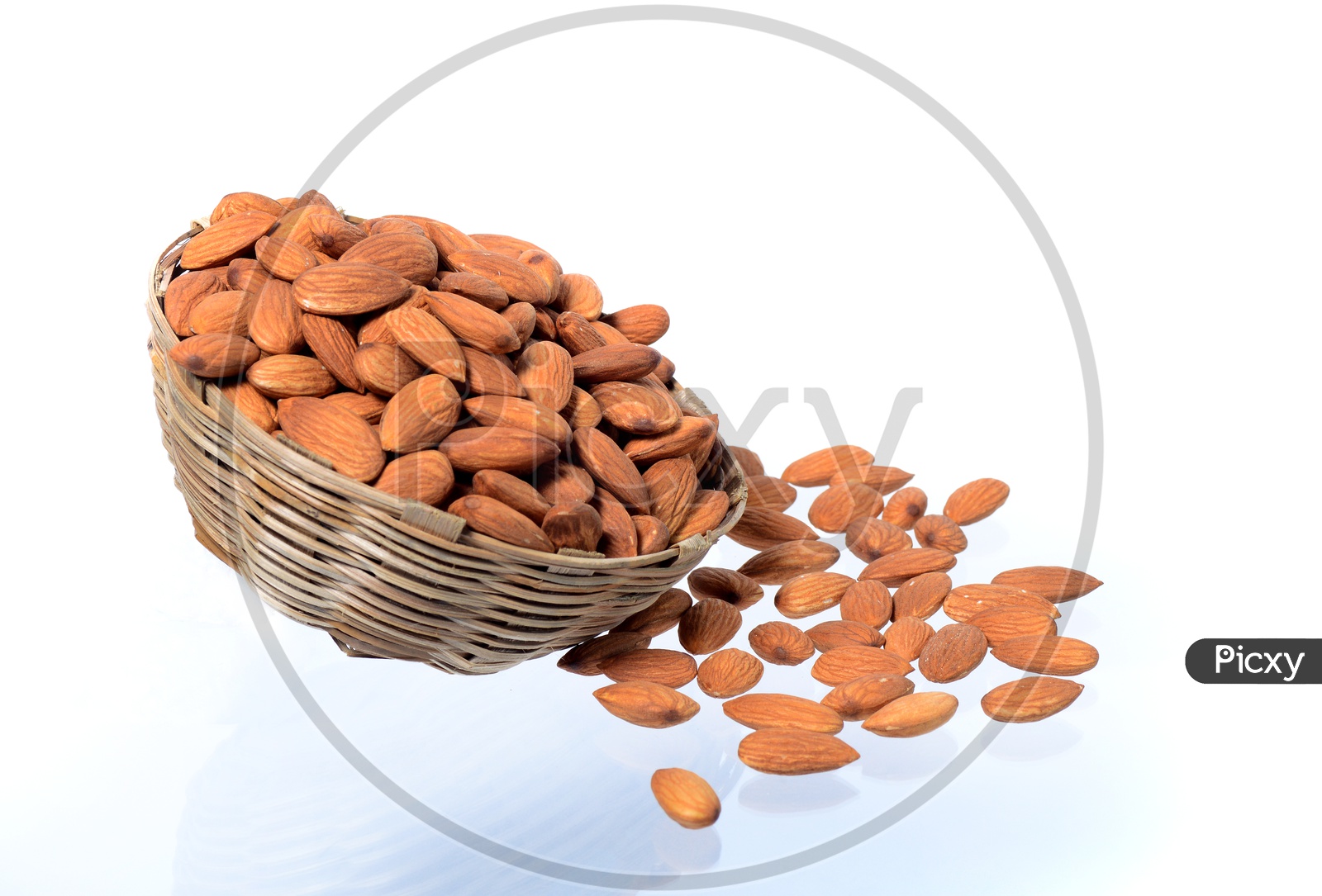 Image of Almonds Or Badam Nuts Heap On a Wooden Weaved Bowl On An ...