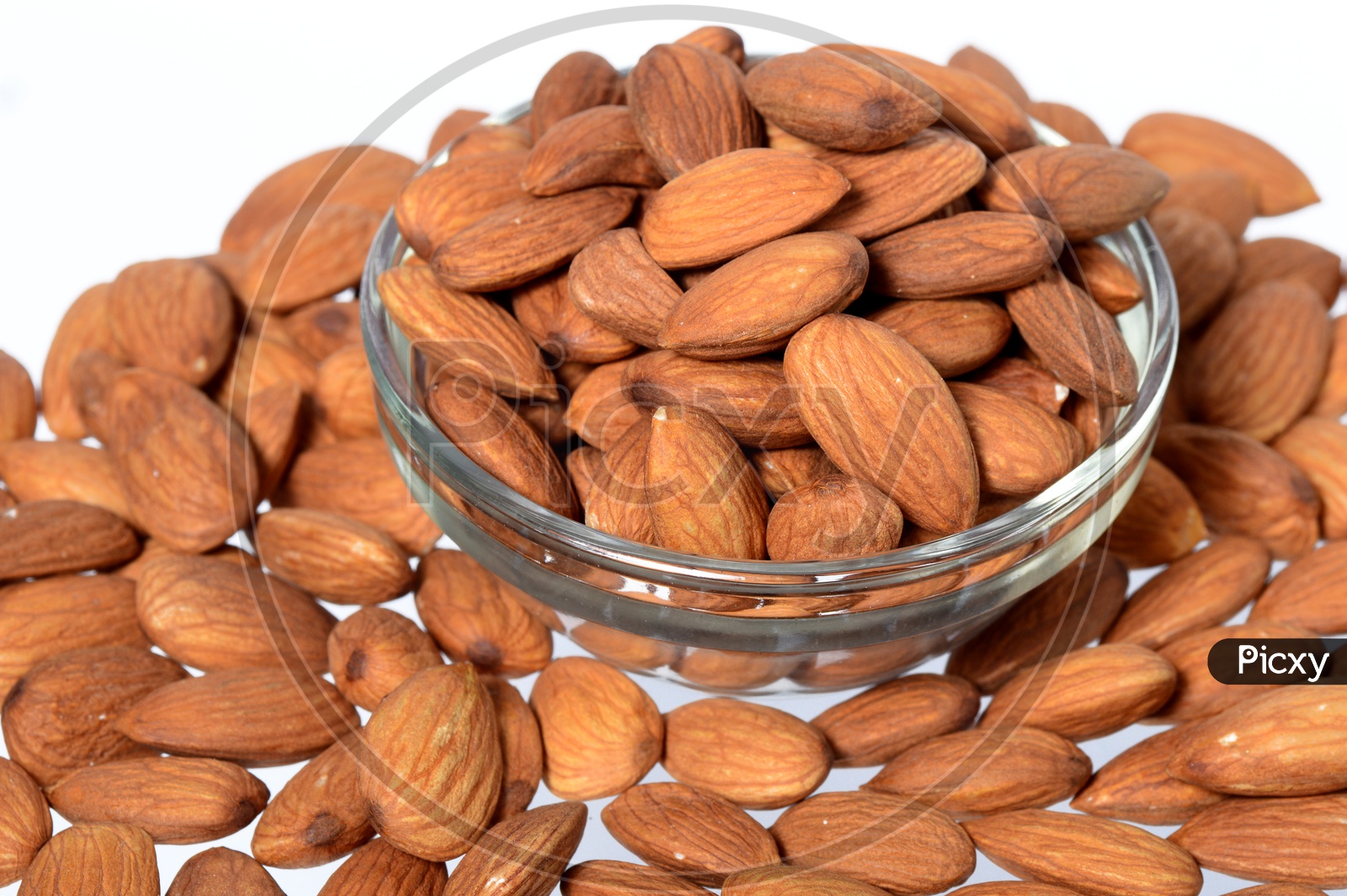 Image of Almonds Or Badam Nuts Heap In a Glass Bowl On an Isolated ...