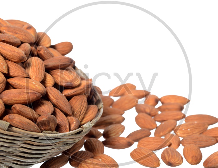 Image of Almonds Or Badam On a Wooden Weaved Bowl On An Isolated White ...