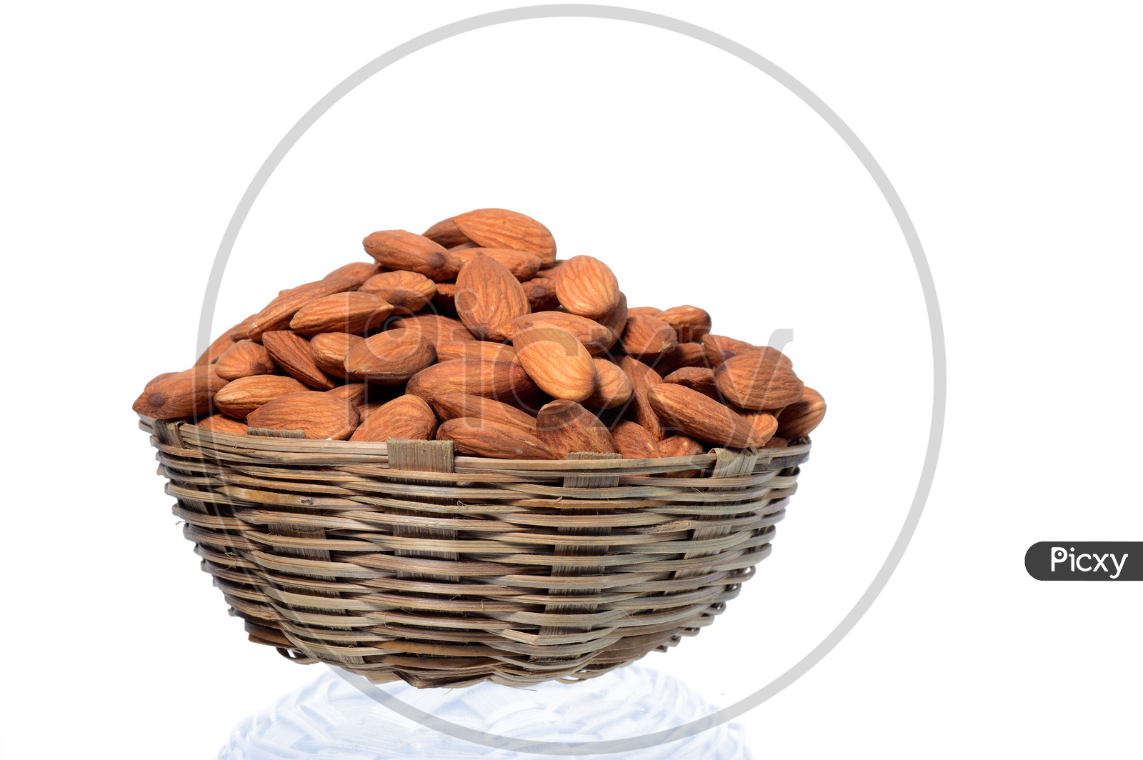 Image of Almonds Or Badam Nuts Heap On a Wooden Weaved Bowl On An ...