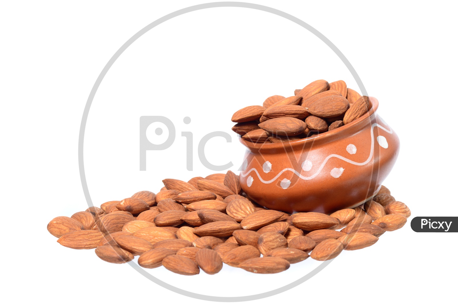 Image of Almonds Or Badam Nuts In a Clay Bowl With a Heap On an ...