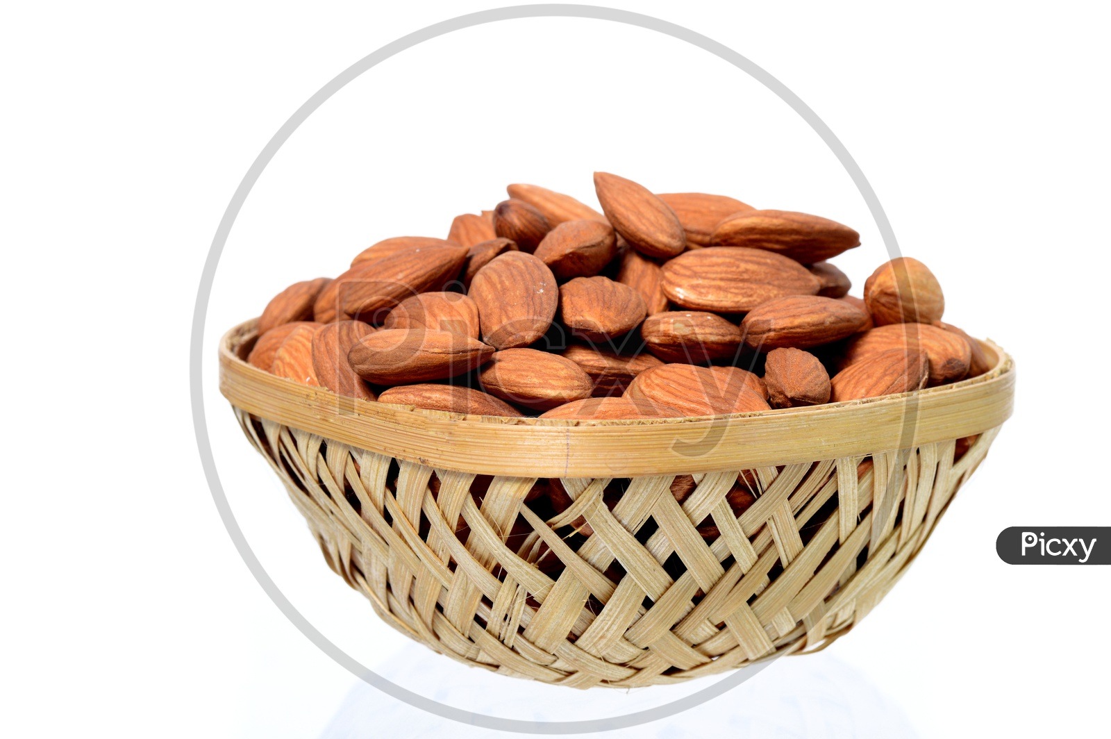 Image of Almonds Or Badam On a Wooden Weaved Bowl On An Isolated White ...