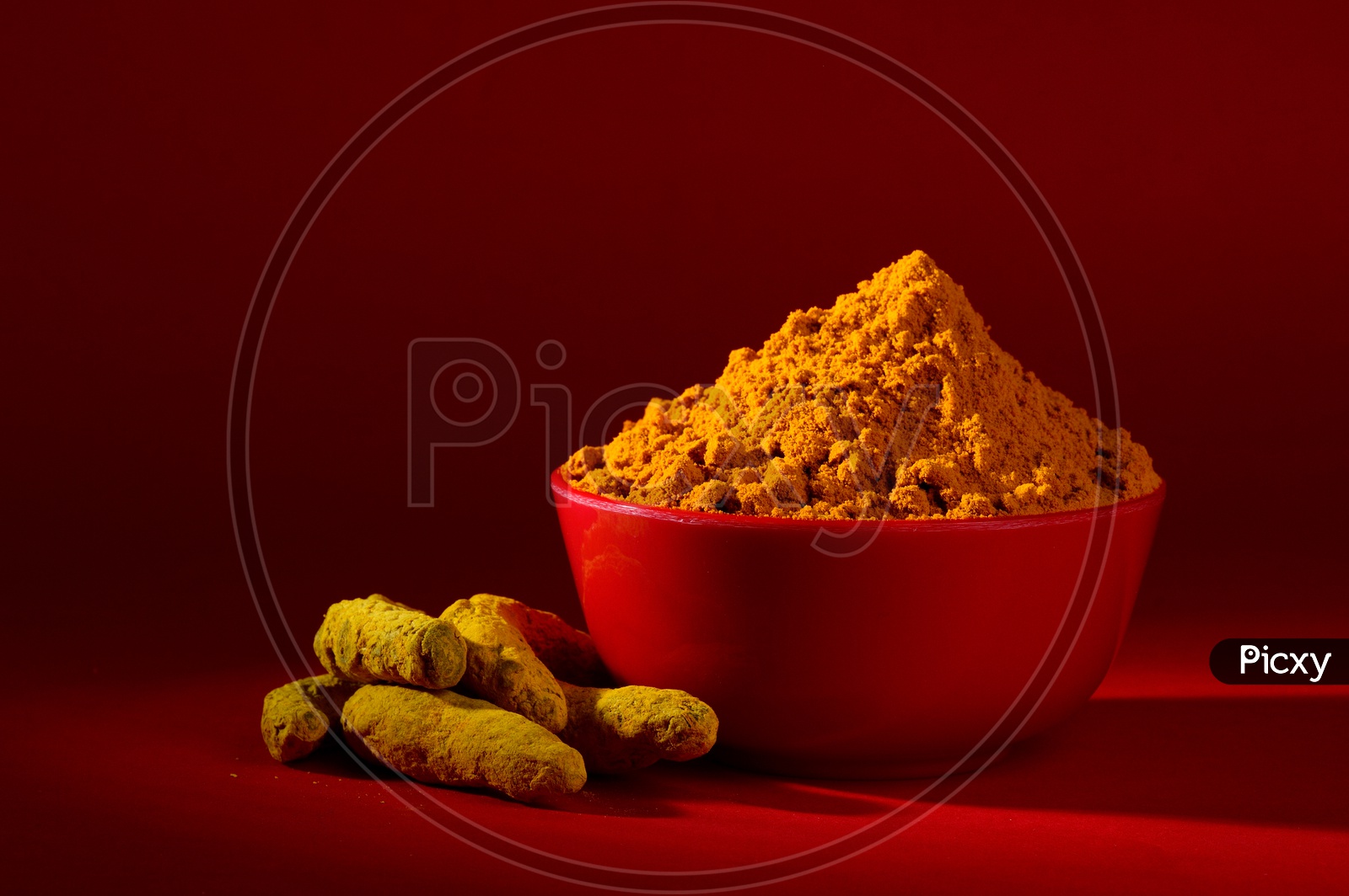 Image of Dry Turmeric powder and roots or barks in red bowl on red ...