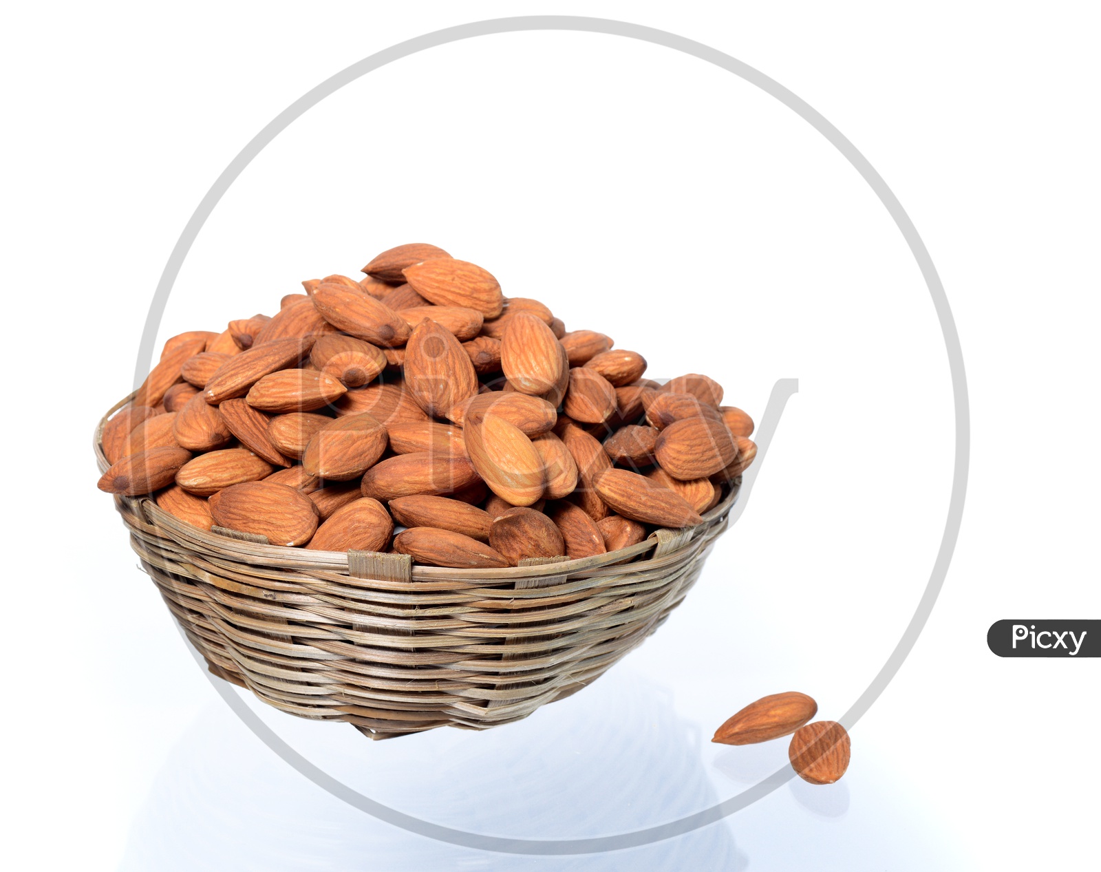 Image of Almonds Or Badam Nuts Heap On a Wooden Weaved Bowl On An ...