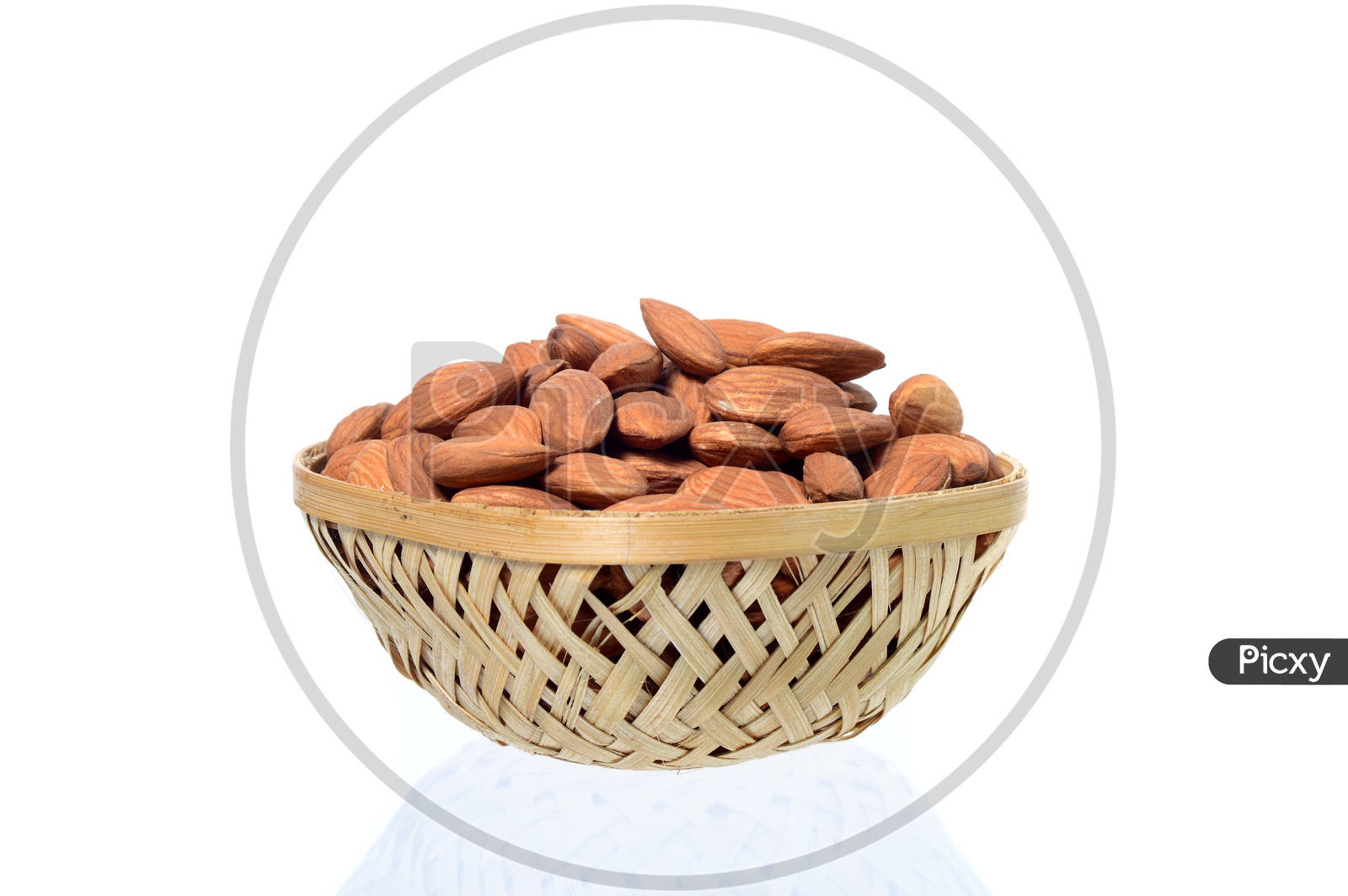 Image of Almonds Or Badam On a Wooden Weaved Bowl On An Isolated White ...