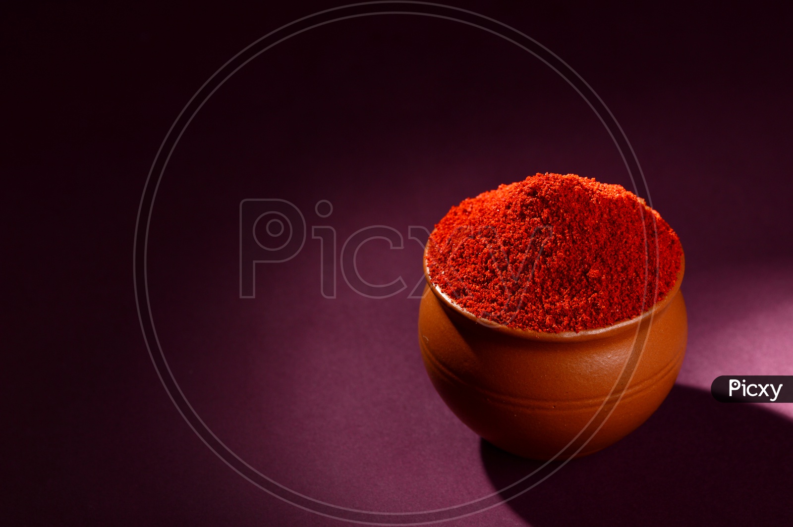 Image of Red Chili Pepper powder in clay pot on dark background ...
