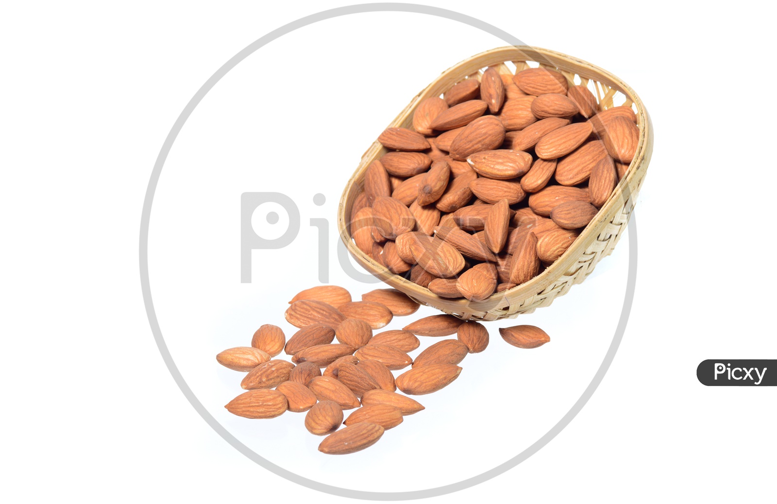 Image of Almonds Or Badam On a Wooden Weaved Bowl On An Isolated White ...