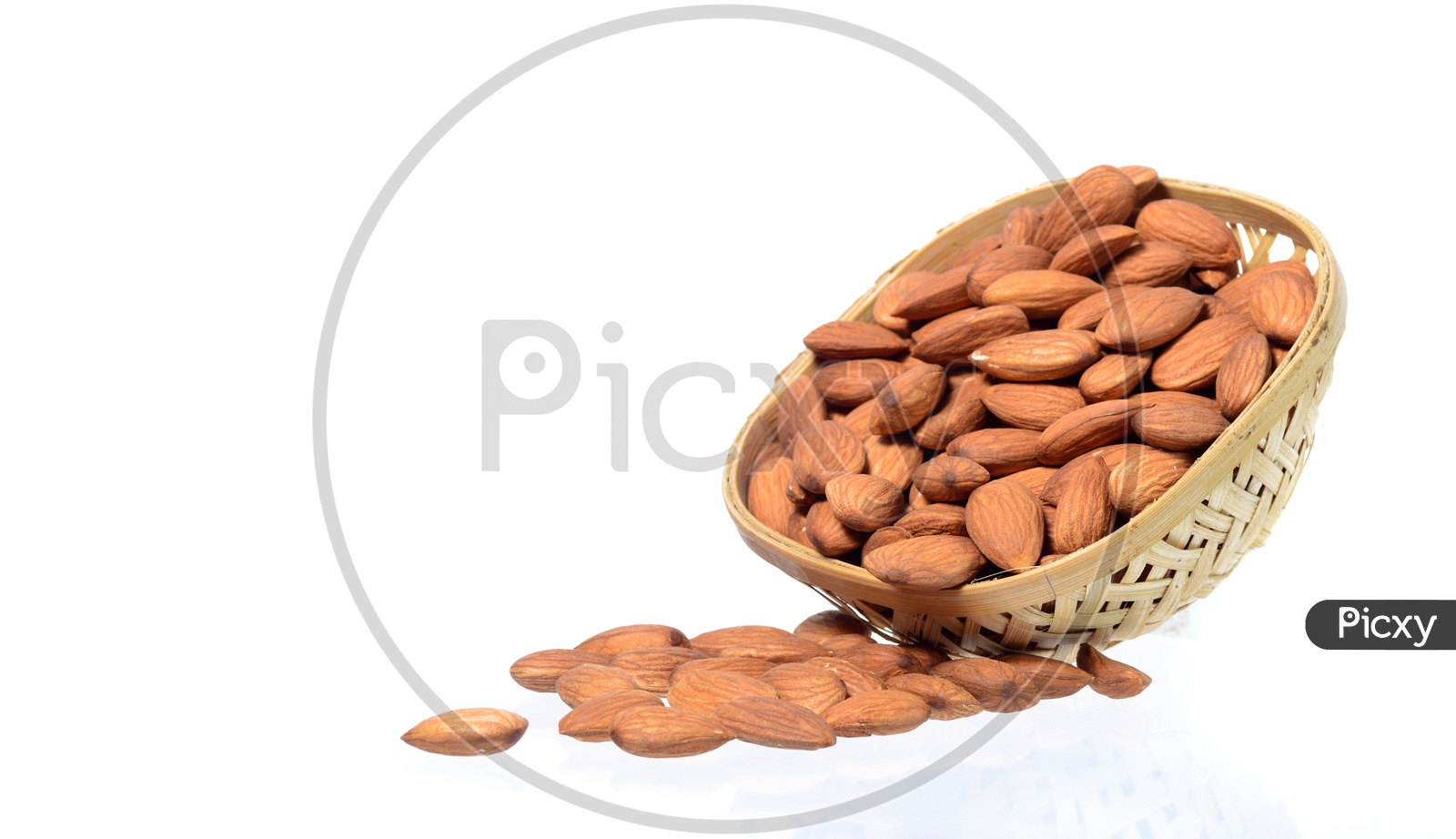 Image of Almonds Or Badam On a Wooden Weaved Bowl On An Isolated White ...
