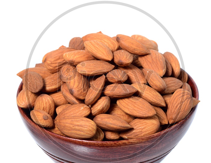 Image of Almonds Or Badam Nuts In a Wooden Bowl With a Heap On an ...