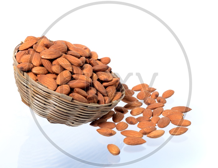Image of Almonds Or Badam Nuts Heap On a Wooden Weaved Bowl On An ...