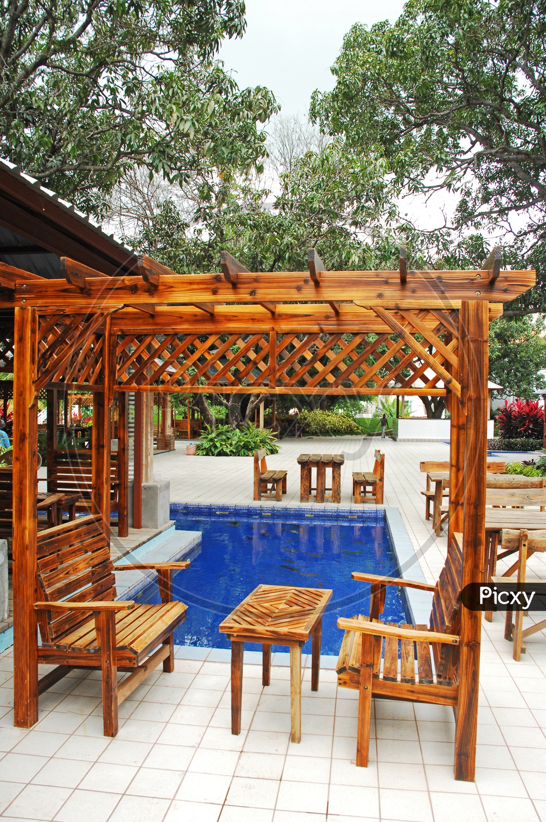 Image of Tables and benches In a Resort pool side-BY152089-Picxy
