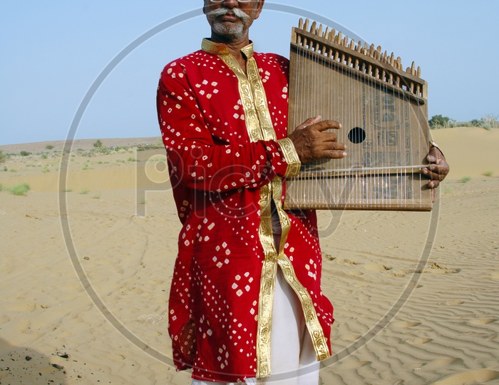Image of Rajasthani Men playing musical instruments in desert-RB464774 ...