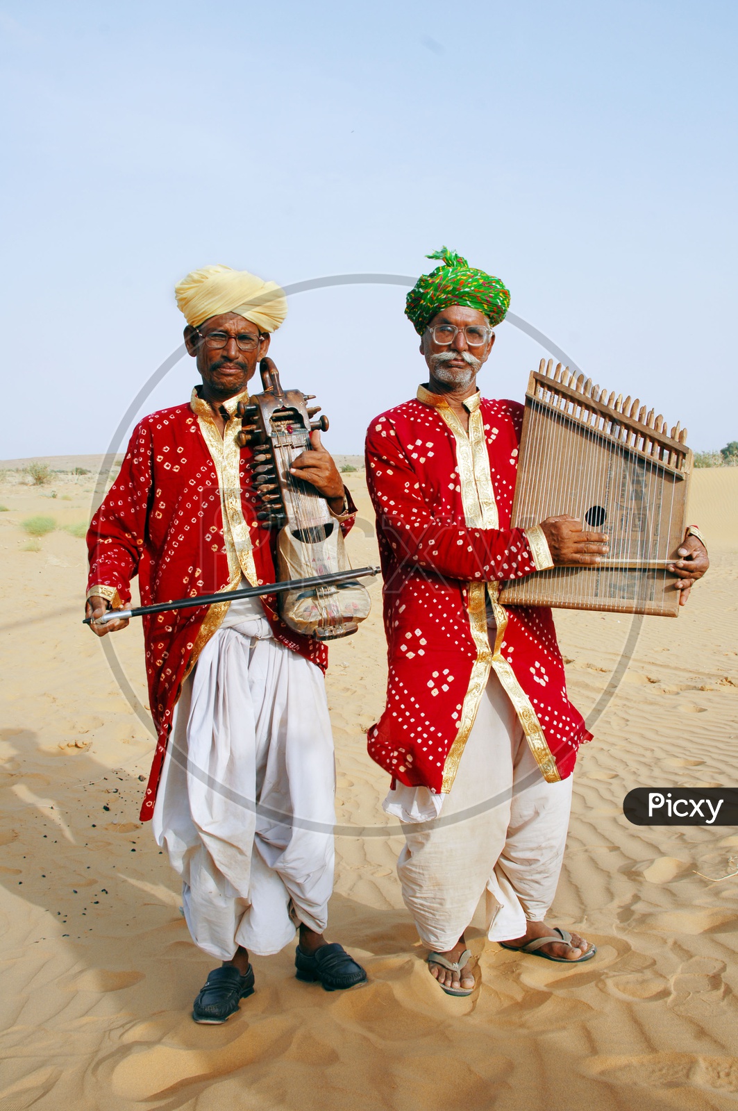 Image of Rajasthani Men playing musical instruments in desert-RB464774 ...