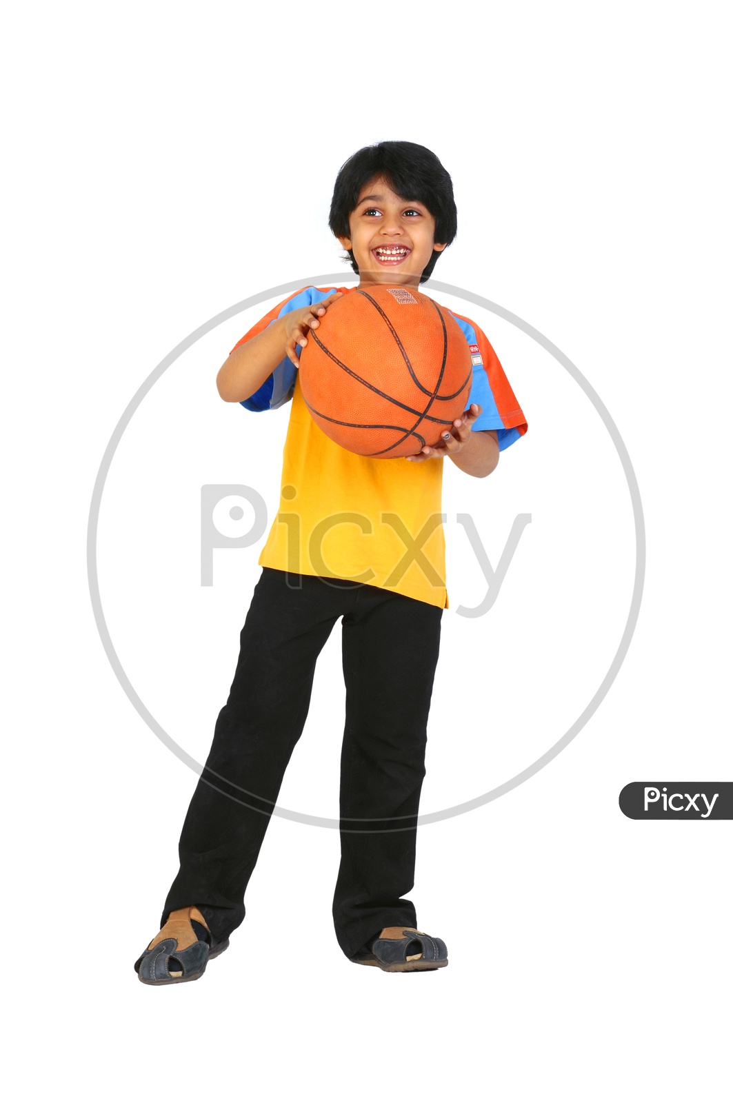 Image of An Indian boy playing with basketball in white background ...