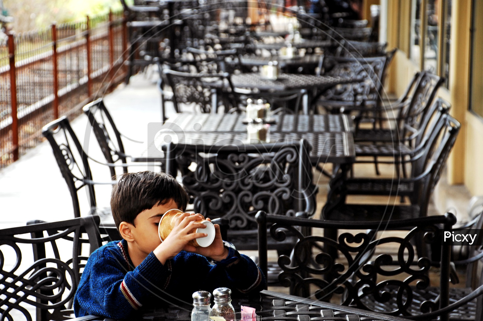 Image of A Young Boy Drinking Coffee in a Cup-KE536657-Picxy