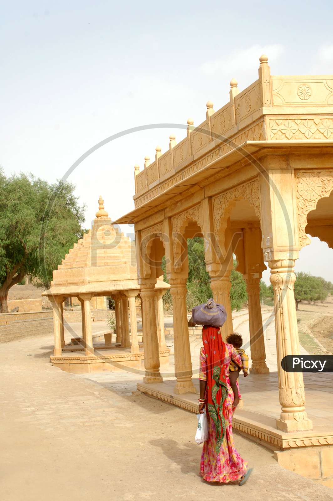 Image of Poor Rajasthani woman walking along with her child-LY435250-Picxy
