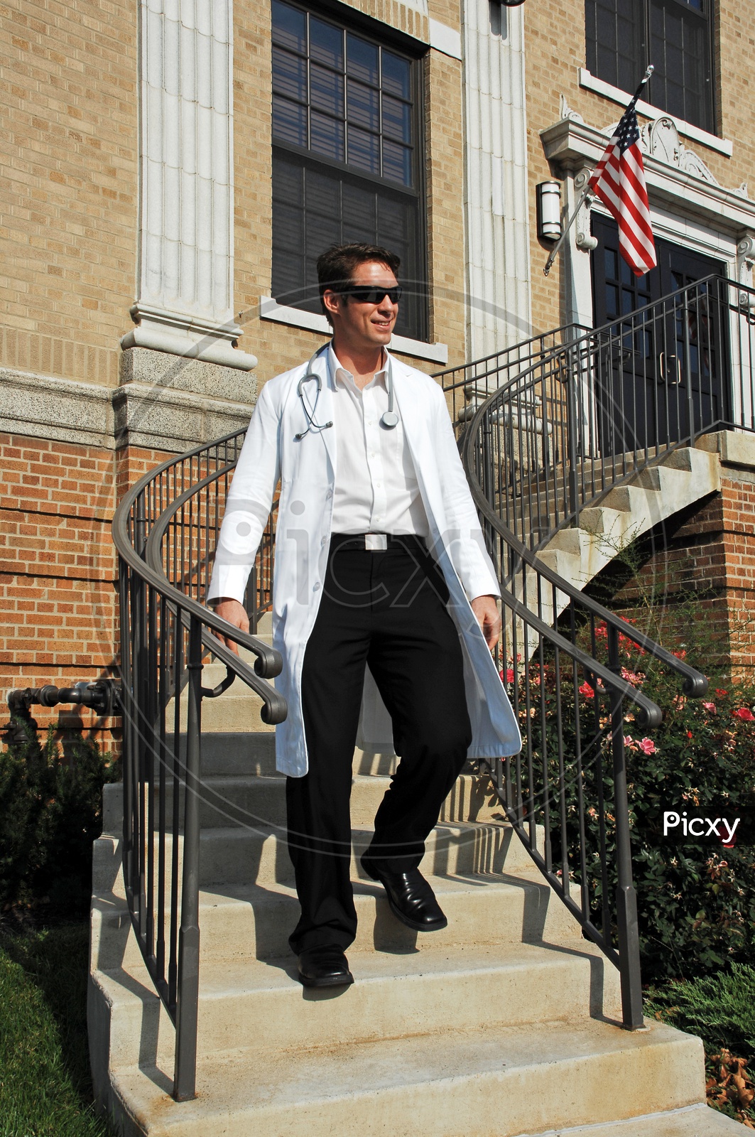 Image of An young male doctor walking down the steps-FX529073-Picxy