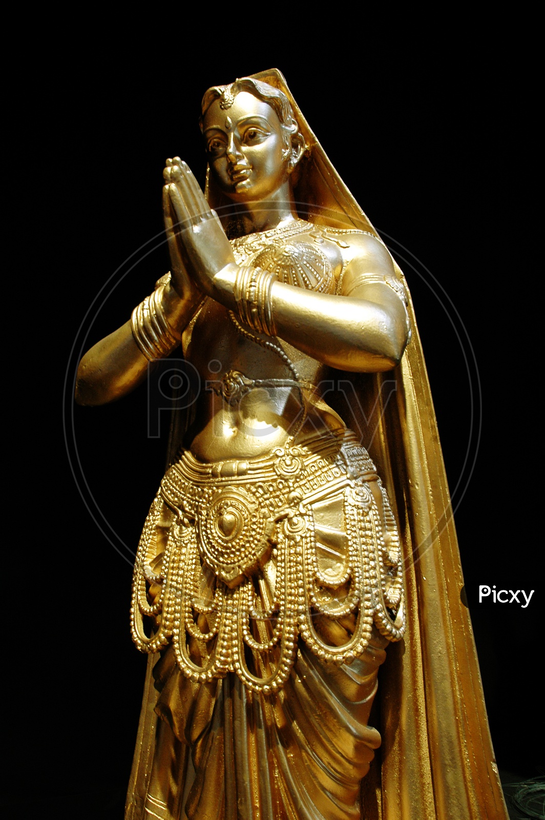 Image of Gold colored woman sculpture in namaste pose-OB547811-Picxy