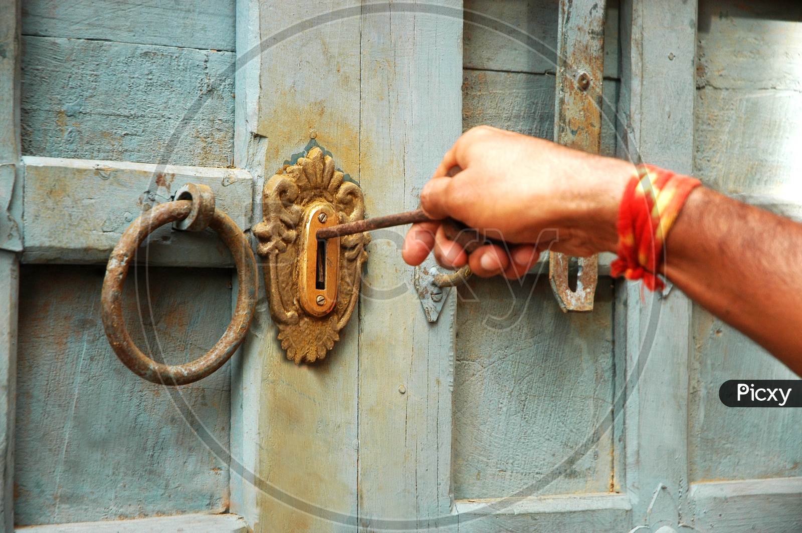 Image of A man unlocking an ancient door-IP919412-Picxy