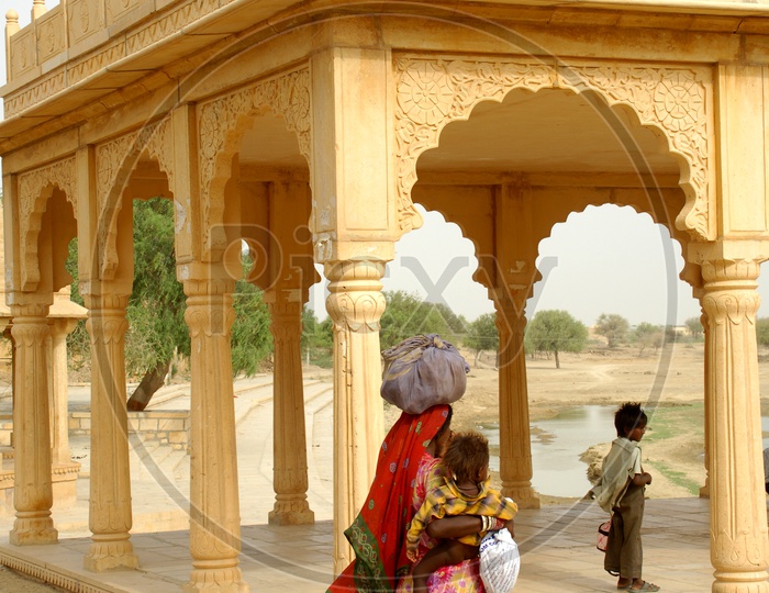 Image of Poor Rajasthani woman walking along with her child-LY435250-Picxy