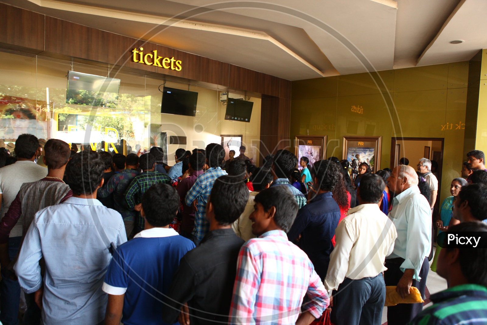 Image of Fans Waiting at Tickets Counter in a Movie Theater-HW619507-Picxy