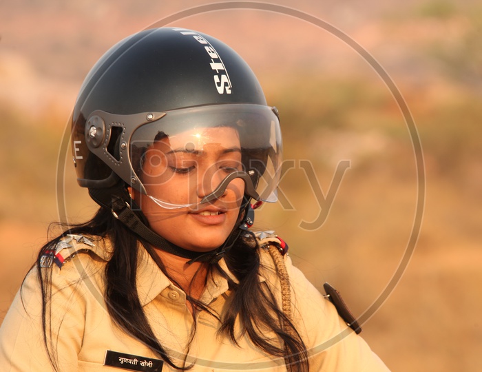 Image of A Woman Or Lady Police Officer Riding A Bike-XZ548457-Picxy