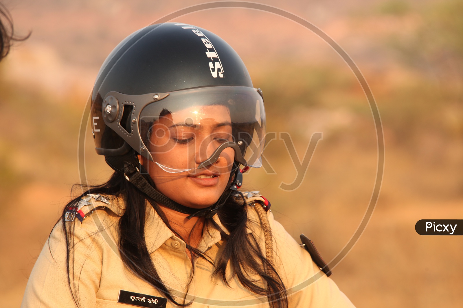 Image of A Woman Or Lady Police Officer Riding A Bike-XZ548457-Picxy
