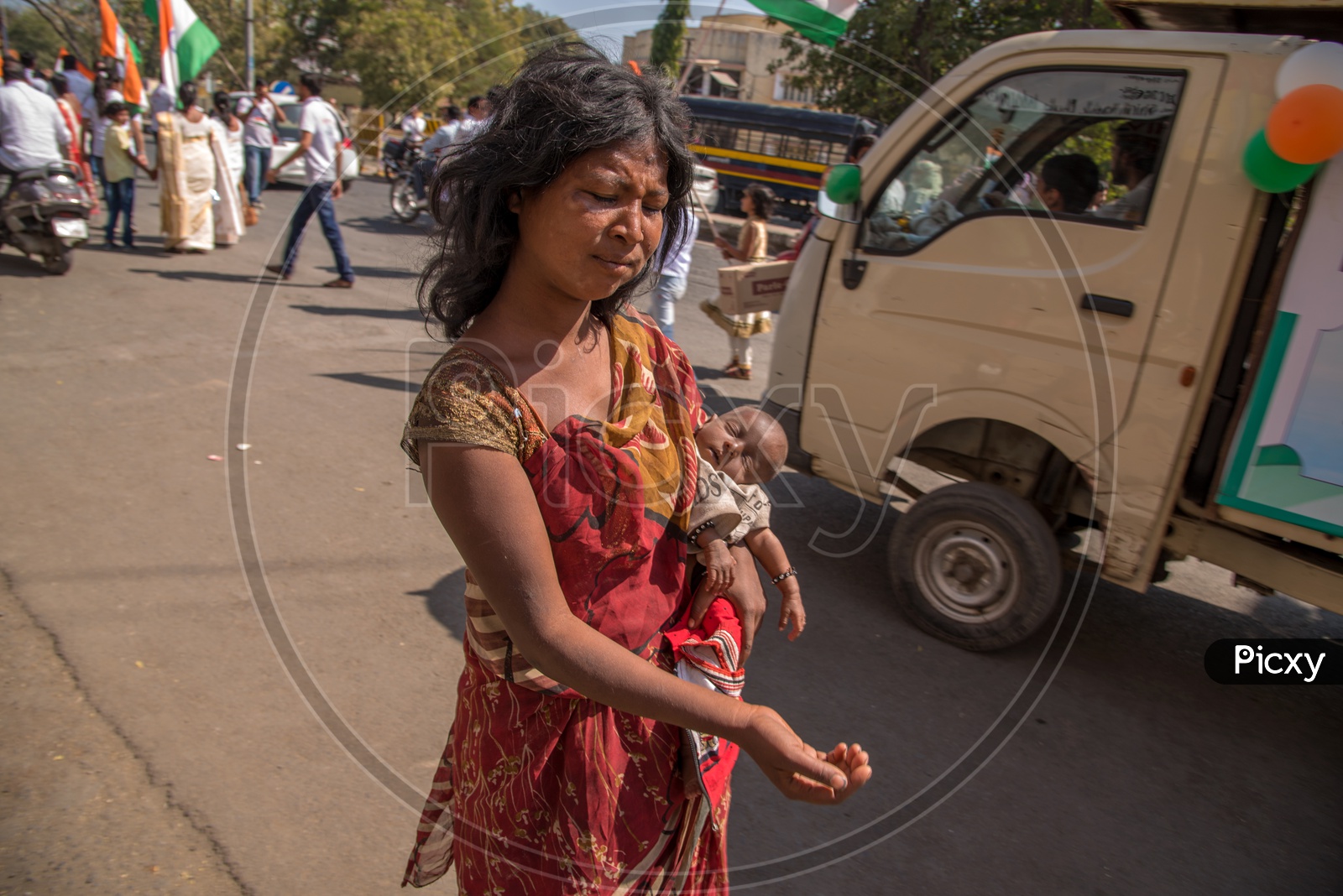 Image of A Woman Beggar Along With a Child in her Arms On the Streets ...