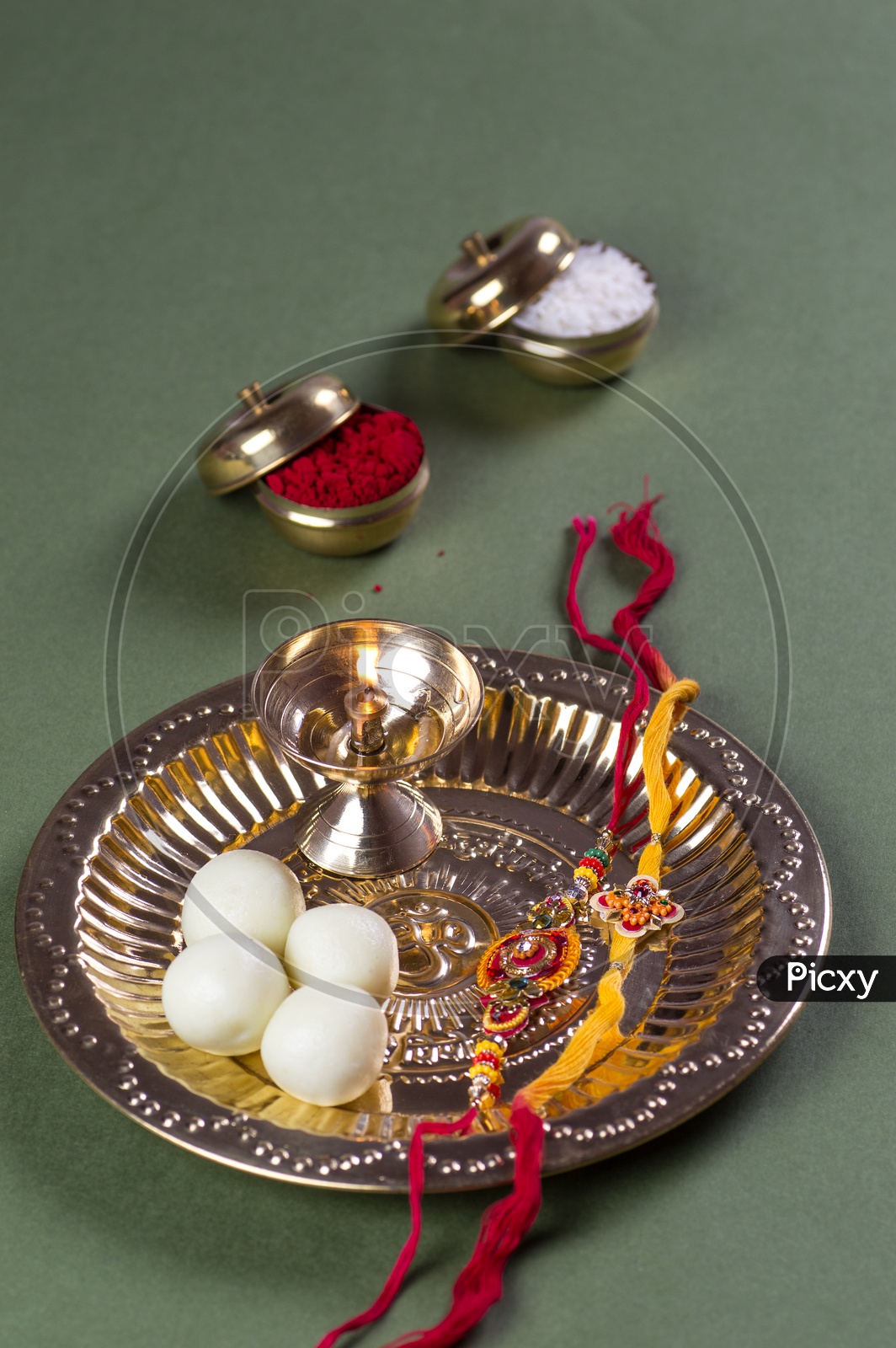 Image of An Elegant Rakhi With a Pooja Thali With Sweet , Dia , Rice ...