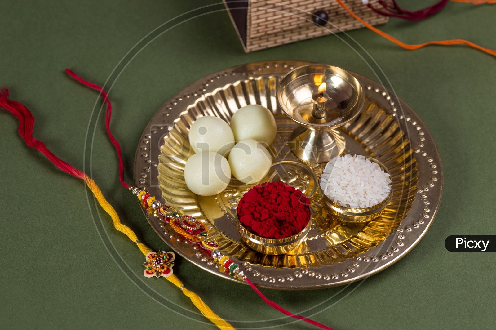 Image of An Elegant Rakhi With a Pooja Thali With Sweet , Dia , Rice ...