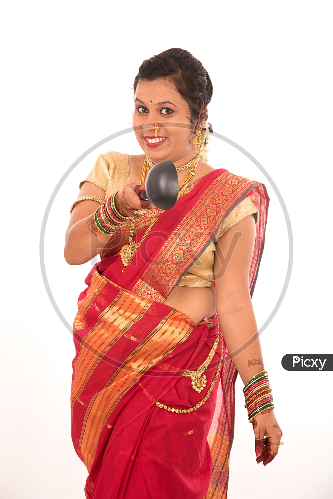 Image of A Young Indian Marathi Woman Holding Cooking Utensil And ...