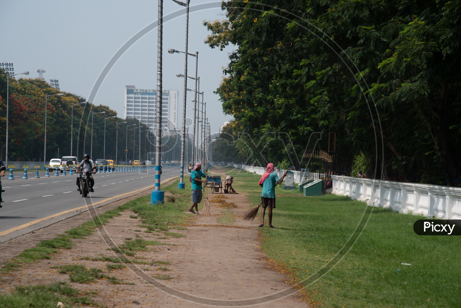 Image of Sanitary Or Municipal Corporation Workers Cleaning the Road ...