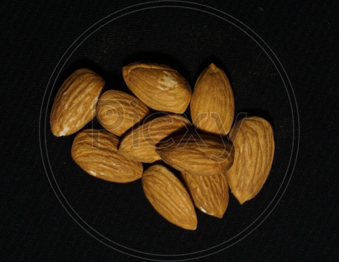 Image of Almonds Or Badam On an isolated Black Background-DK558251-Picxy