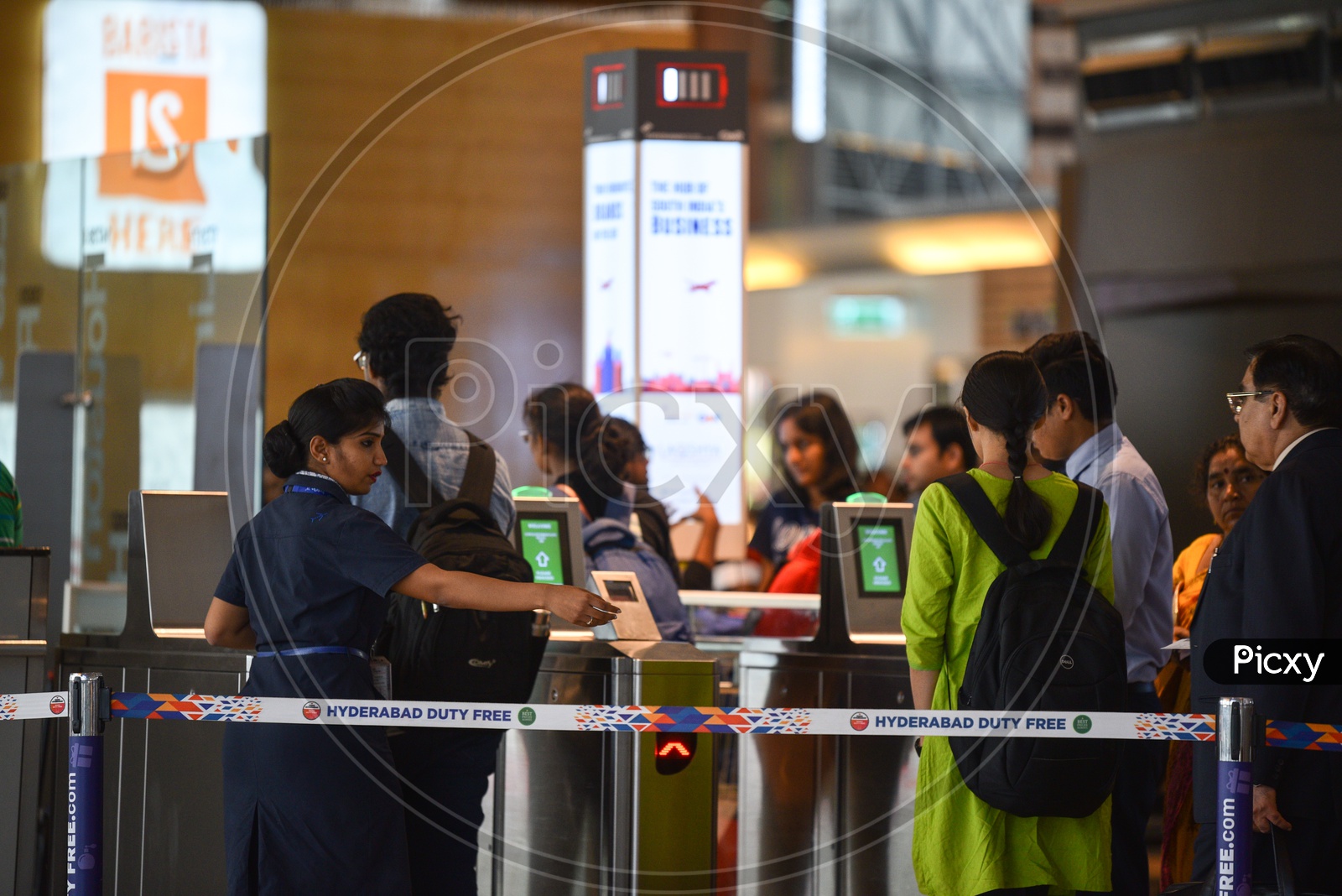 Image of A Woman Security Officer Checking The Passengers at an Airport ...